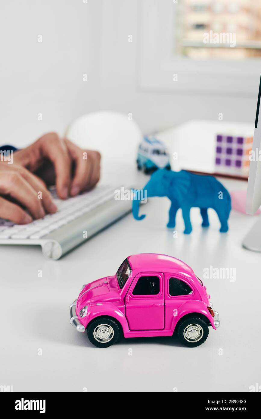closeup of a young caucasian man using a computer sitting at a white ...