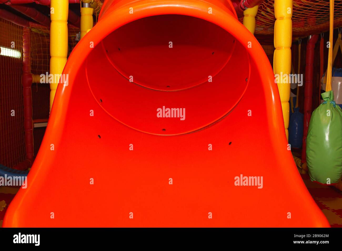 Red Slide in Indoor Kids Playground Stock Photo - Alamy