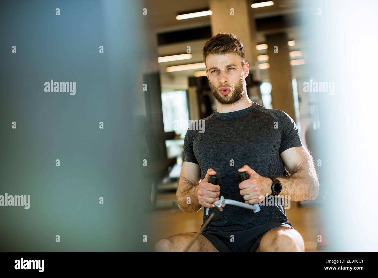 Male using rowing machine hi-res stock photography and images - Alamy
