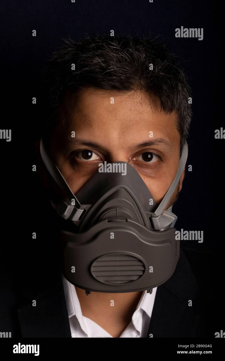 Young handsome with industrial mask to prevent the spread of contagious ...