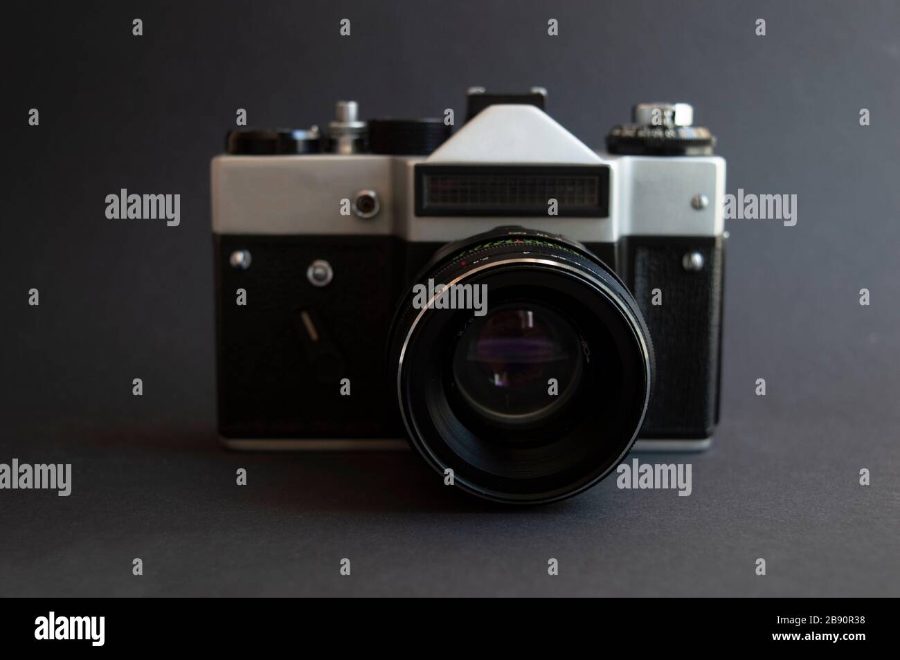 Vintage film photo camera on the dark background. Metal silver and ...