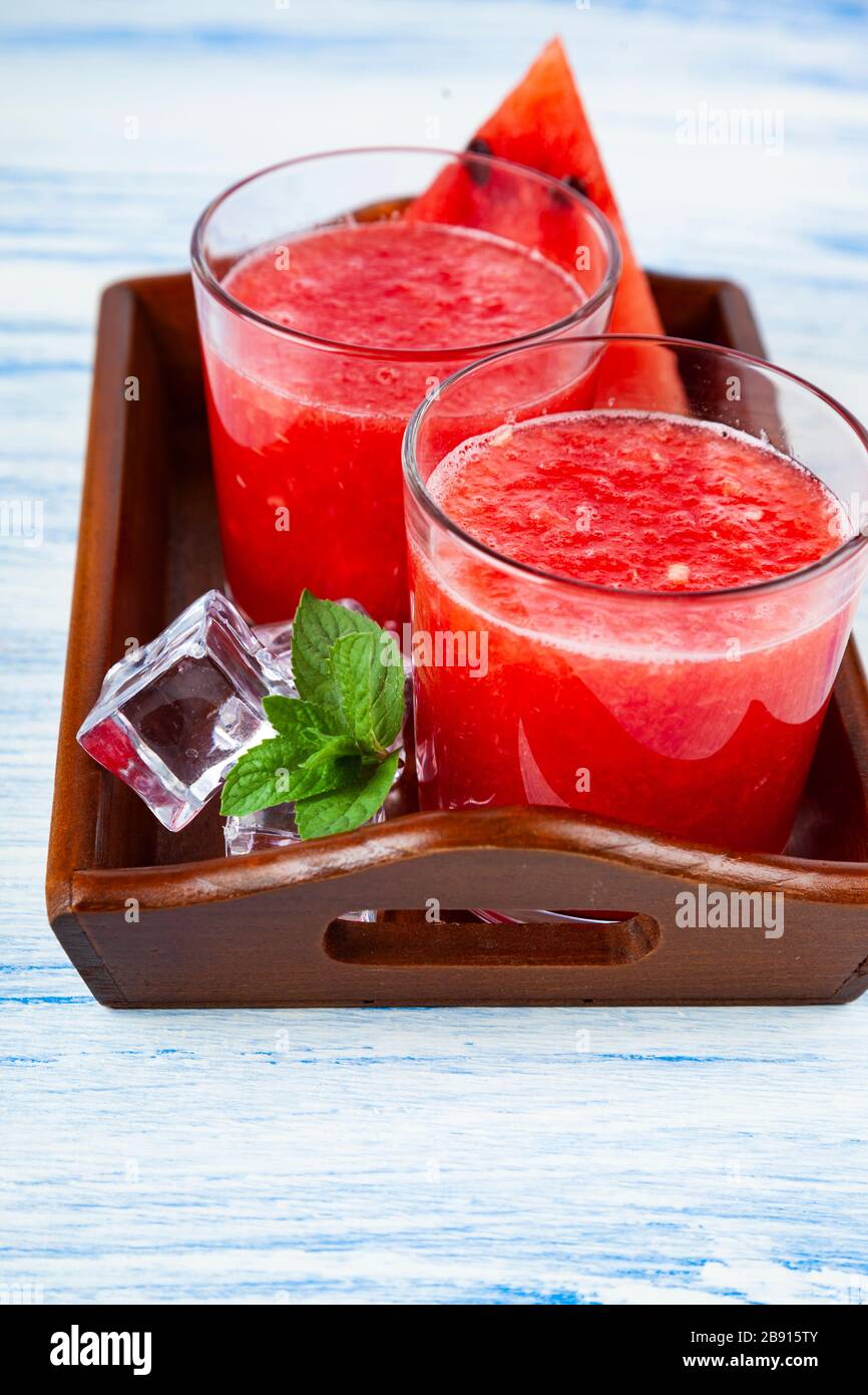 Watermelon juice with ice and mint on a wooden tray.Delicious dessert ...