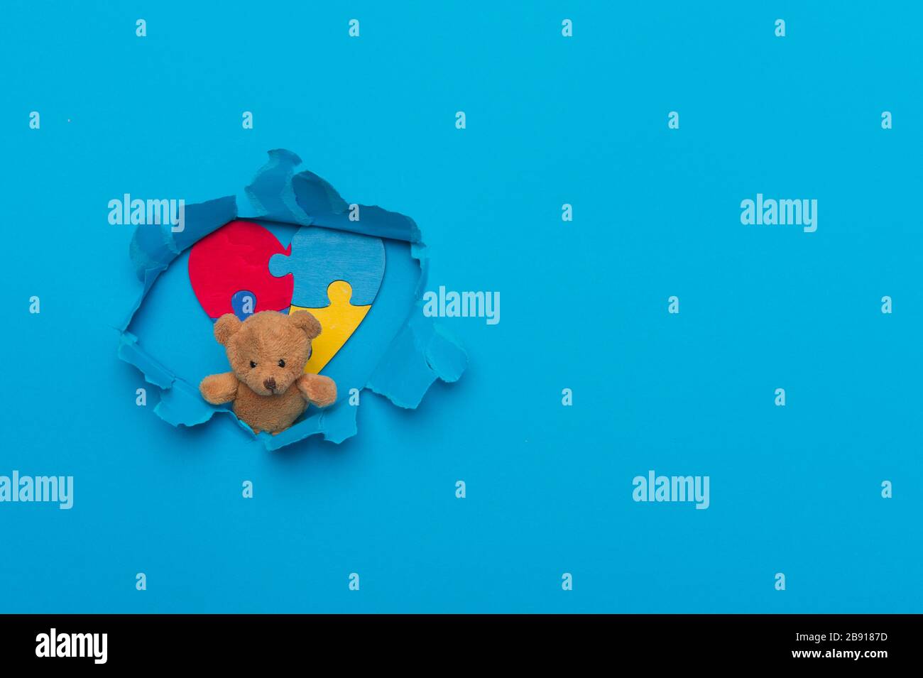 Teddy Bear Holding colorful Puzzle In Paper cut hole. World Autism ...