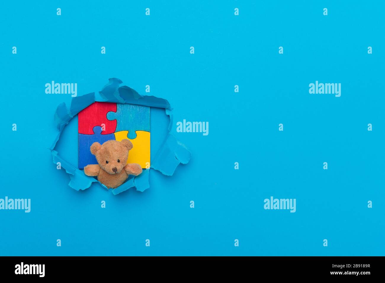 Teddy Bear Holding colorful Puzzle In Paper cut hole. World Autism ...