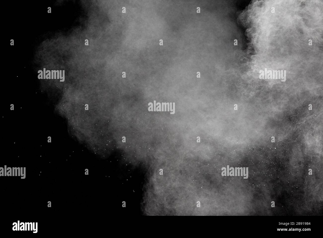 Abstract white powder explosion against black background.White dust ...
