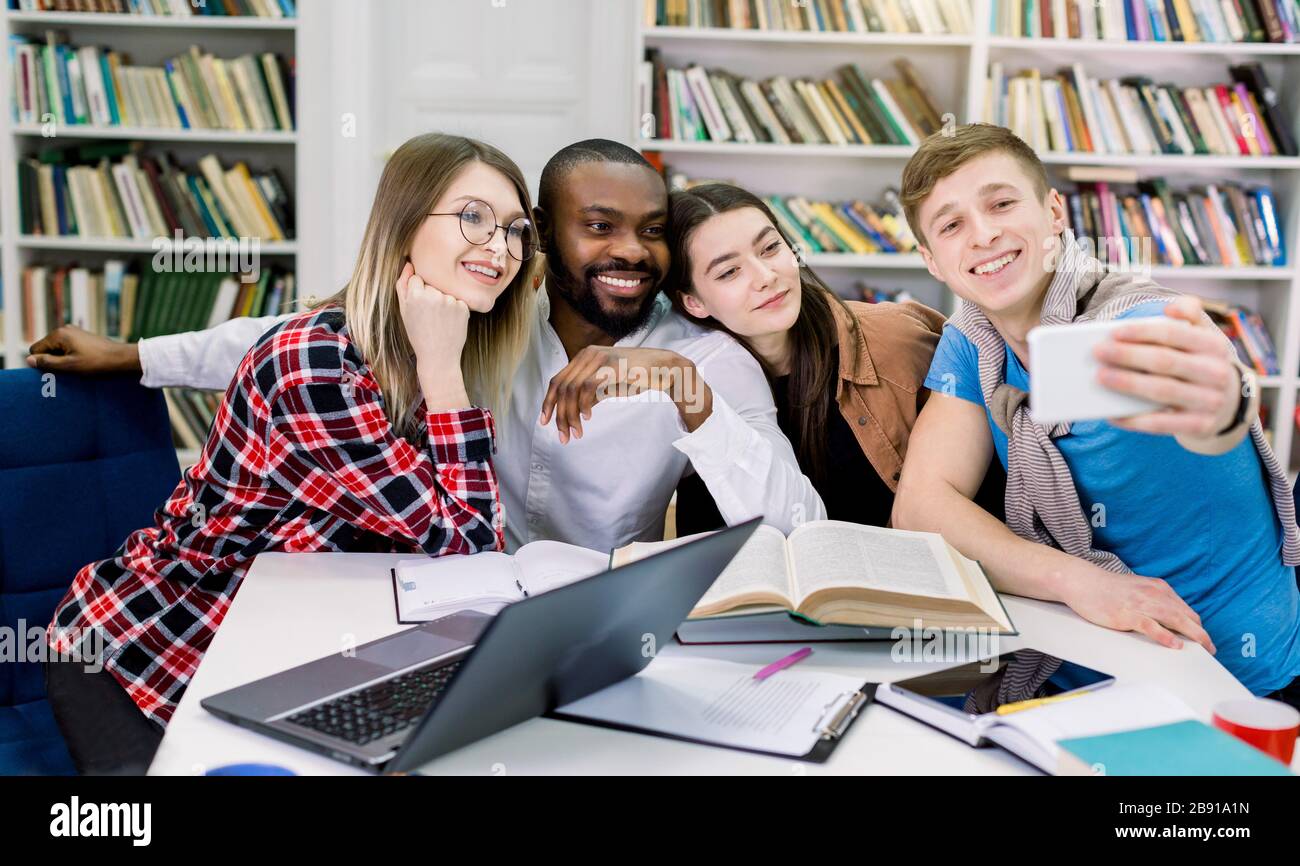 people, fun, education, technology and school concept - happy four ...