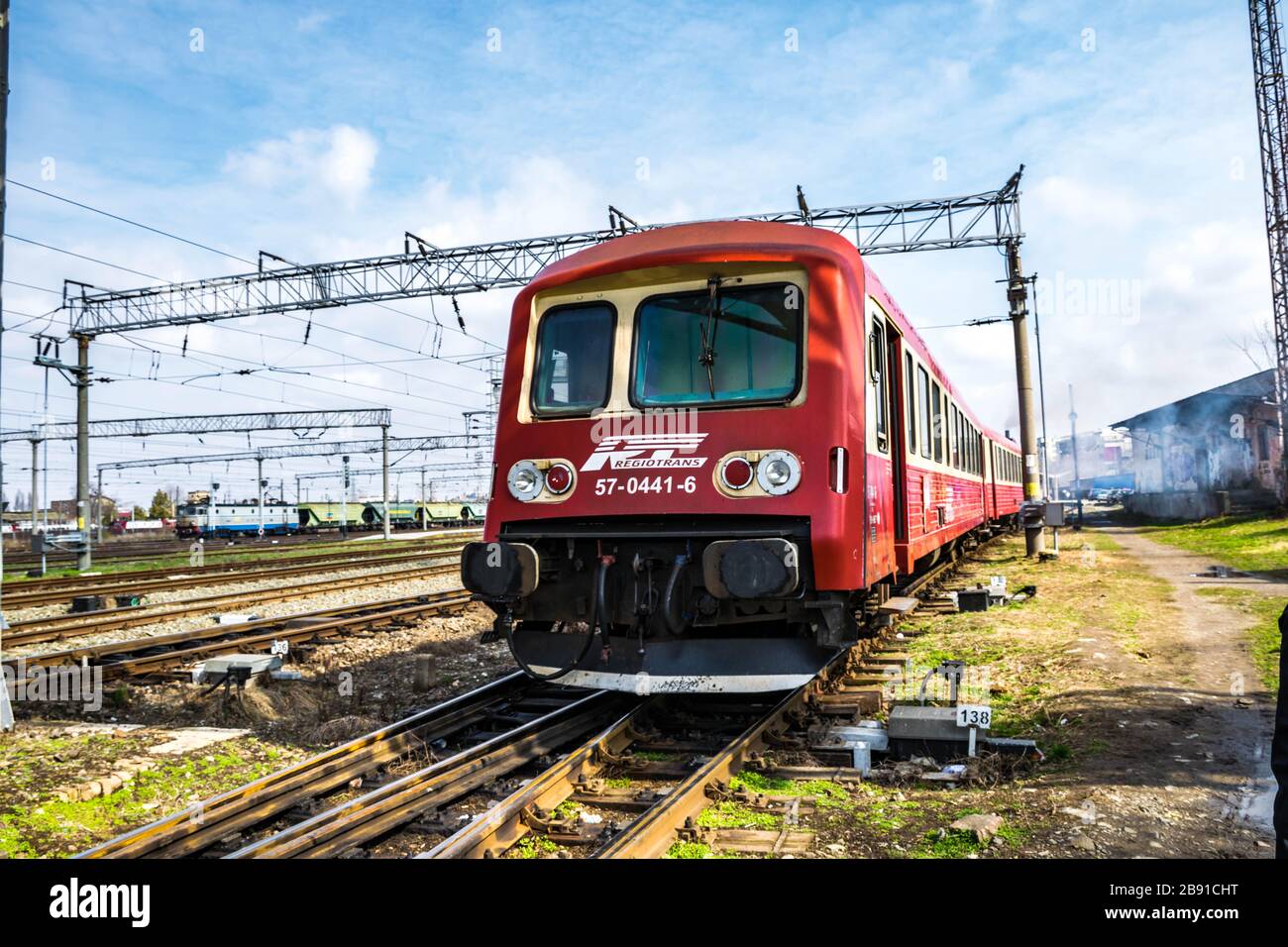 Red diesel locomotive moving on railway. Many railroads in the ...