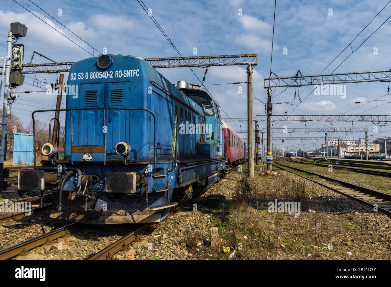 Blue diesel locomotive moving on railway. Blue sky in the background ...
