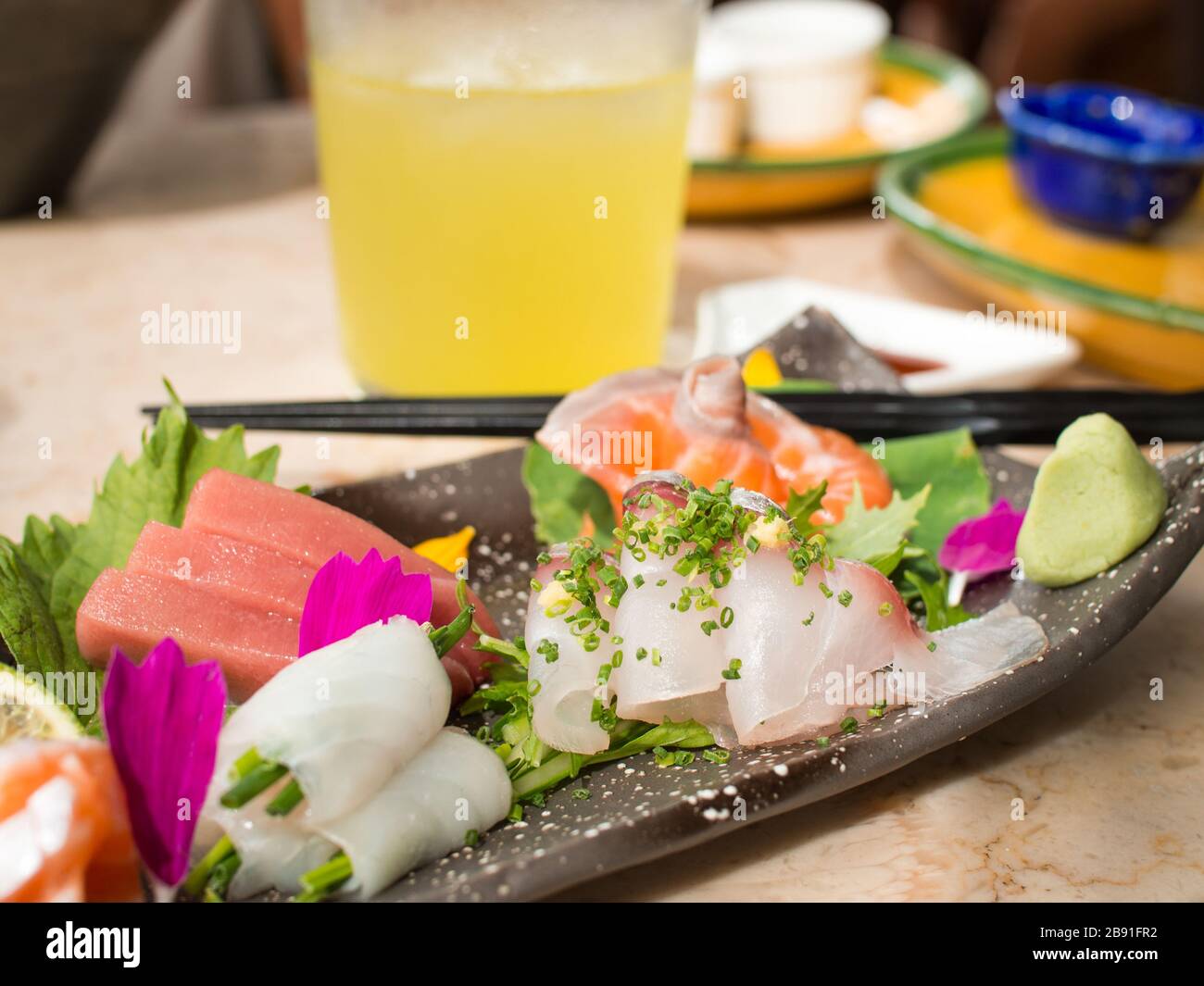 Japanese raw fish on black plate. Also known as Sashimi Stock Photo - Alamy