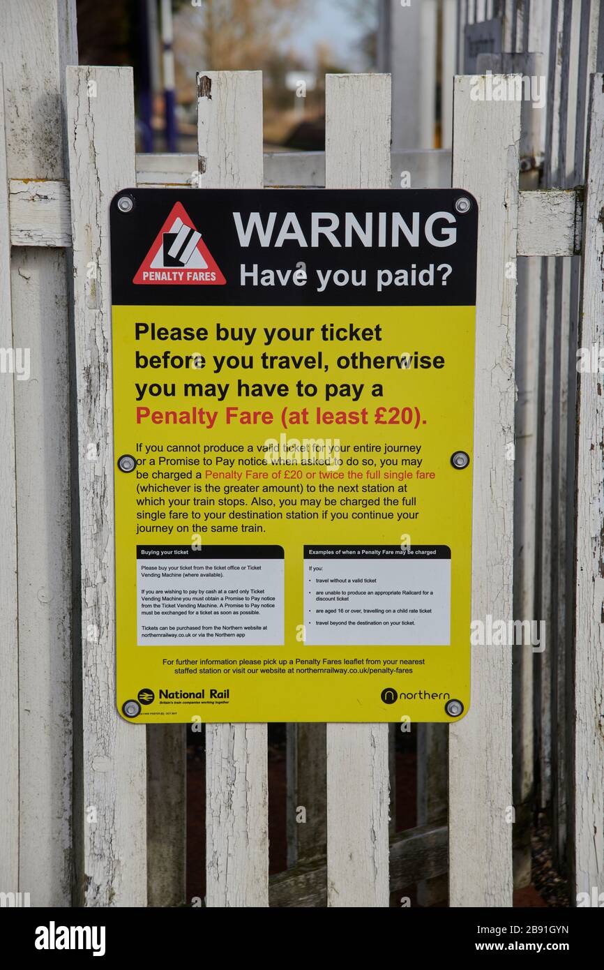 Warning notice to buy a train ticket or risk a fine Stock Photo - Alamy