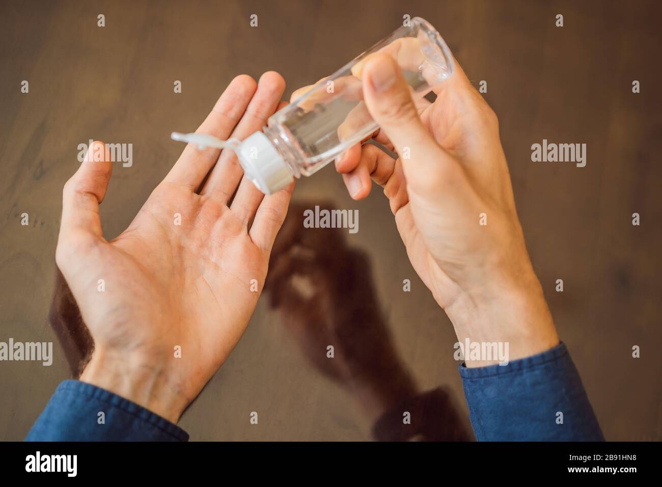 hands using wash hand sanitizer gel. Clear sanitizer in pump bottle ...