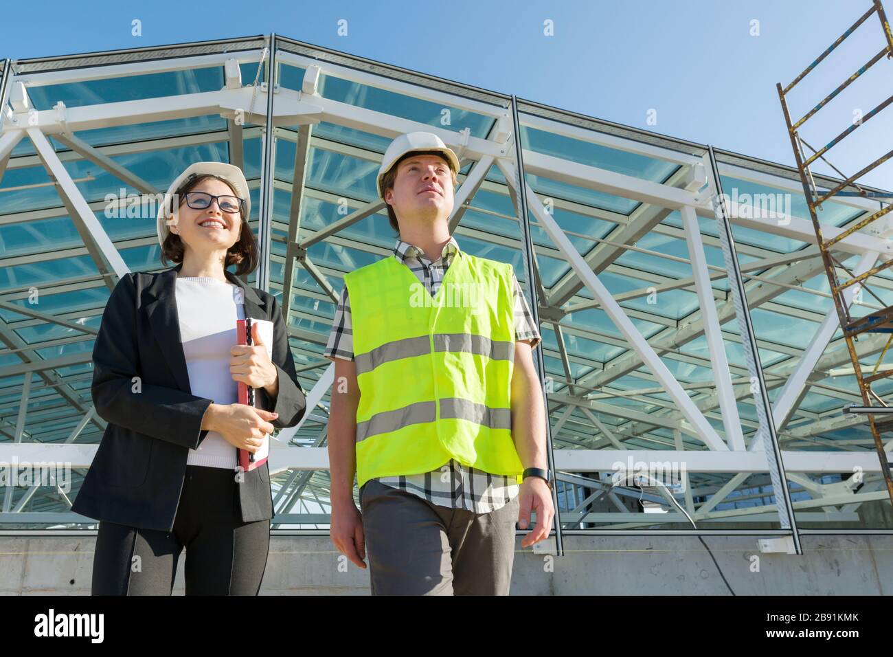 Construction, man and woman builders at construction site, team of ...