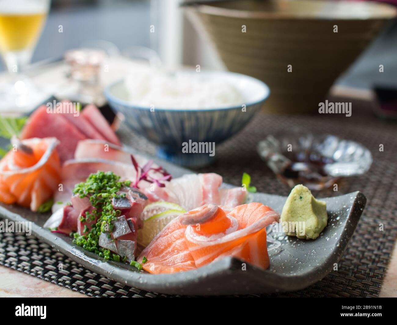 Japanese raw fish on black plate. Also known as Sashimi Stock Photo - Alamy