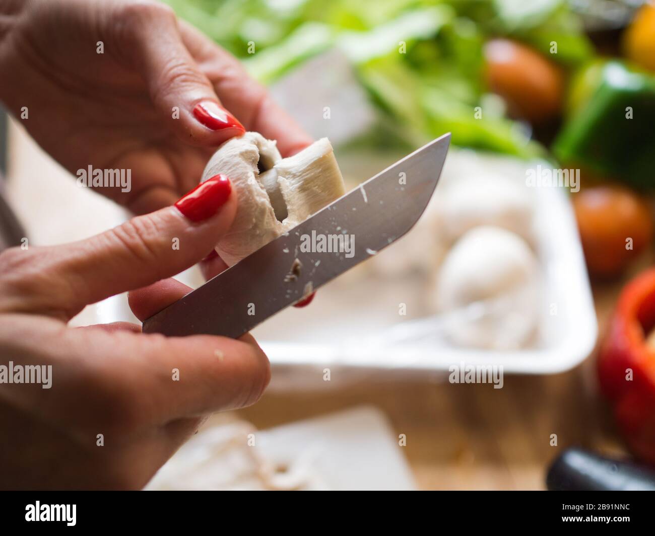 Hands cutting mushrooms hi-res stock photography and images - Alamy