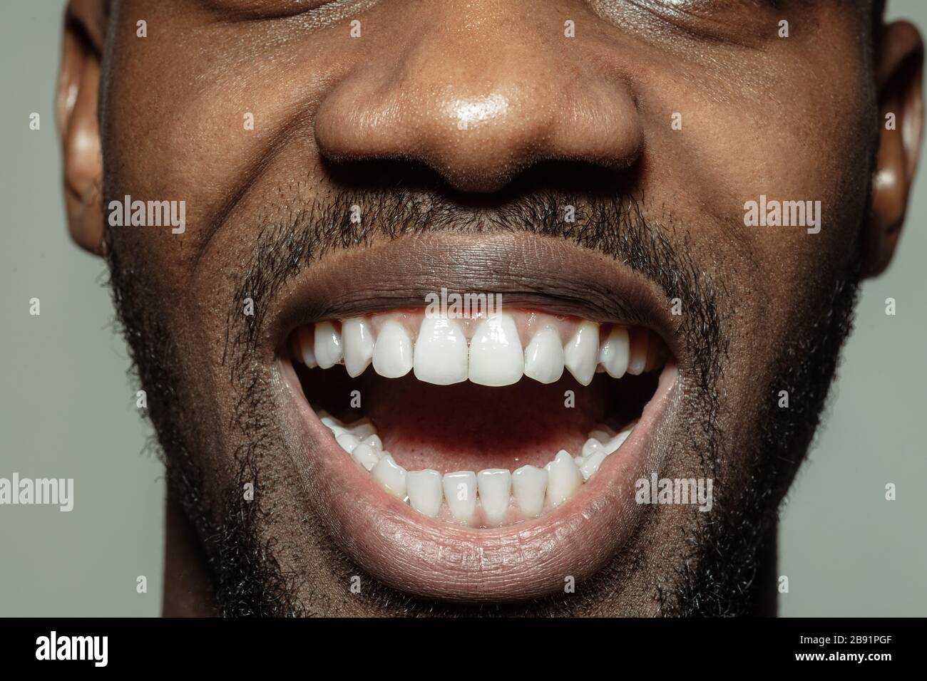 Scretching, teeth showing. Close up of face of beautiful african ...