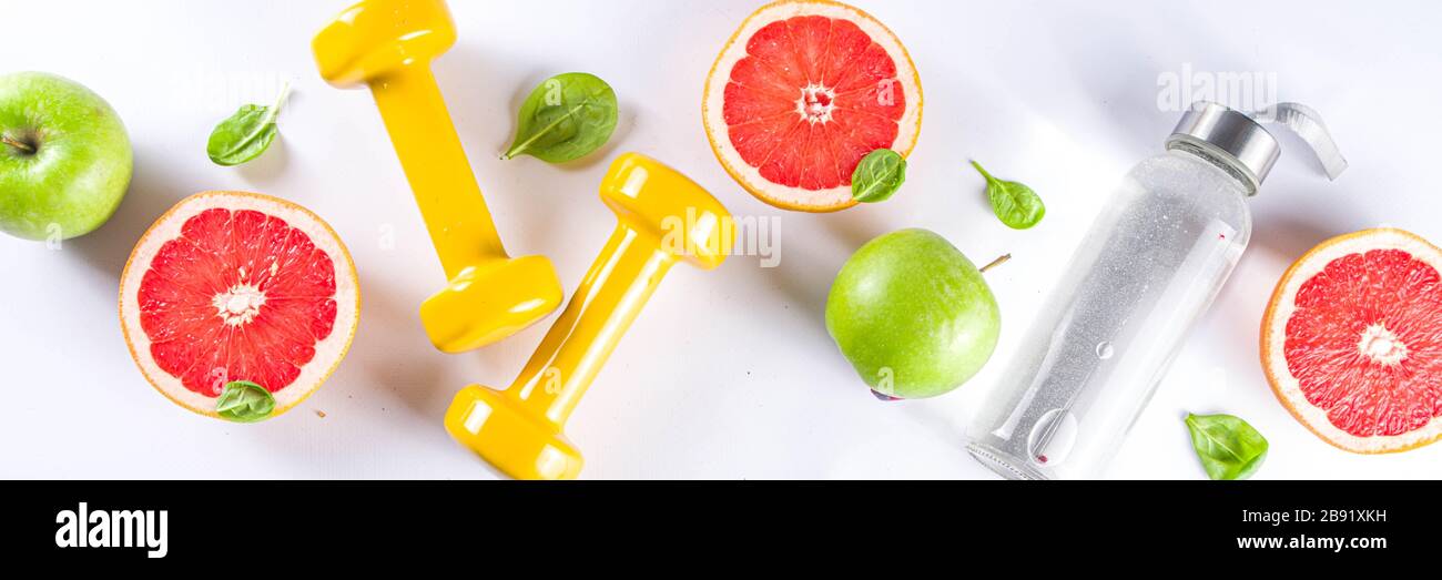 Fitness and healthy food lifestyle concept. Dumbbells, diet fruit and ...