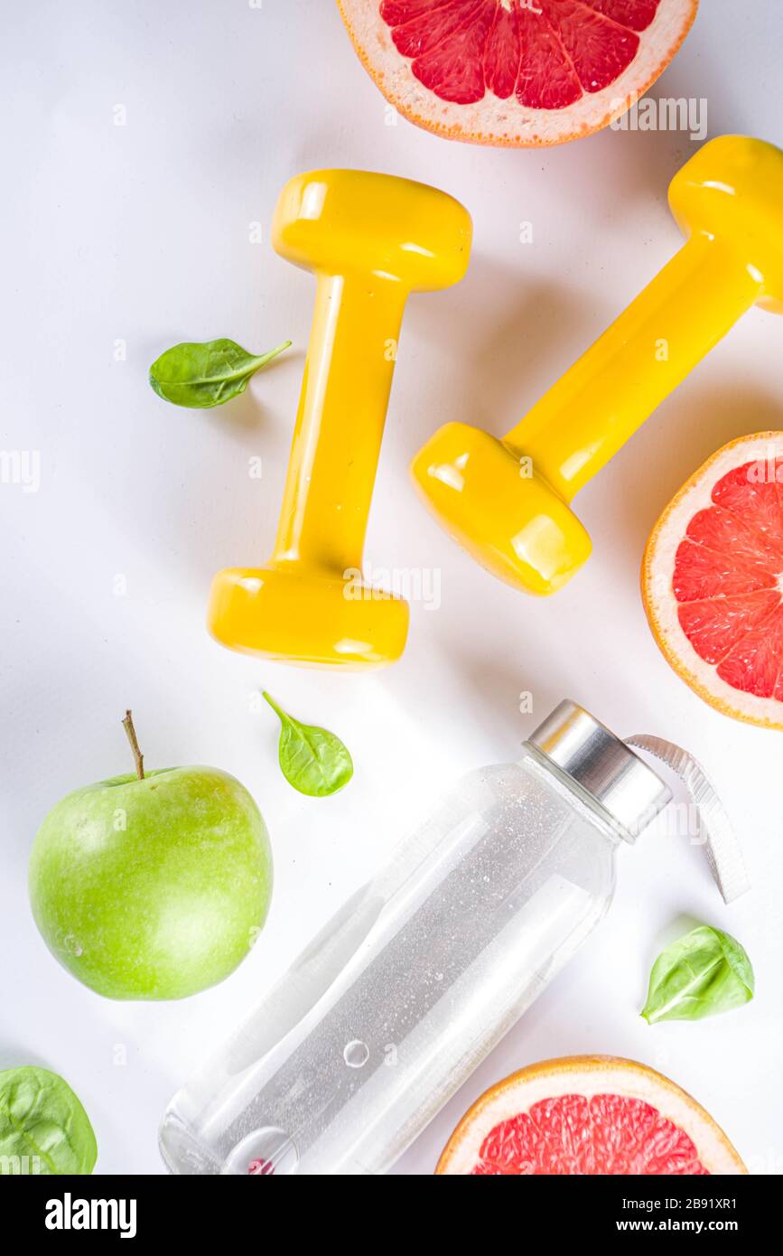 Fitness and healthy food lifestyle concept. Dumbbells, diet fruit and ...