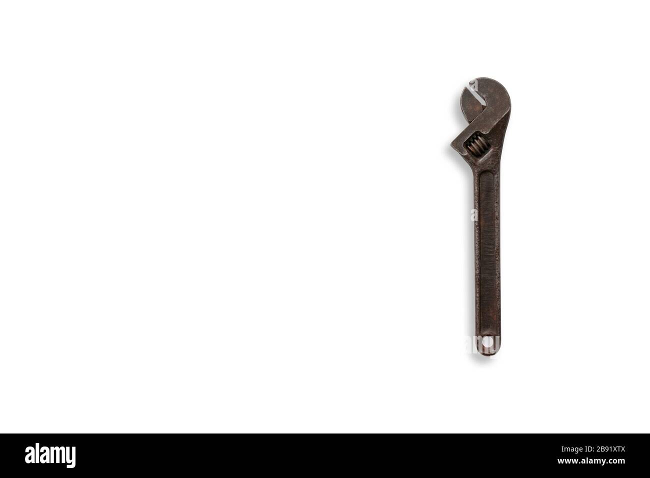 Old rusty adjustable spanner isolated on a white background with ...