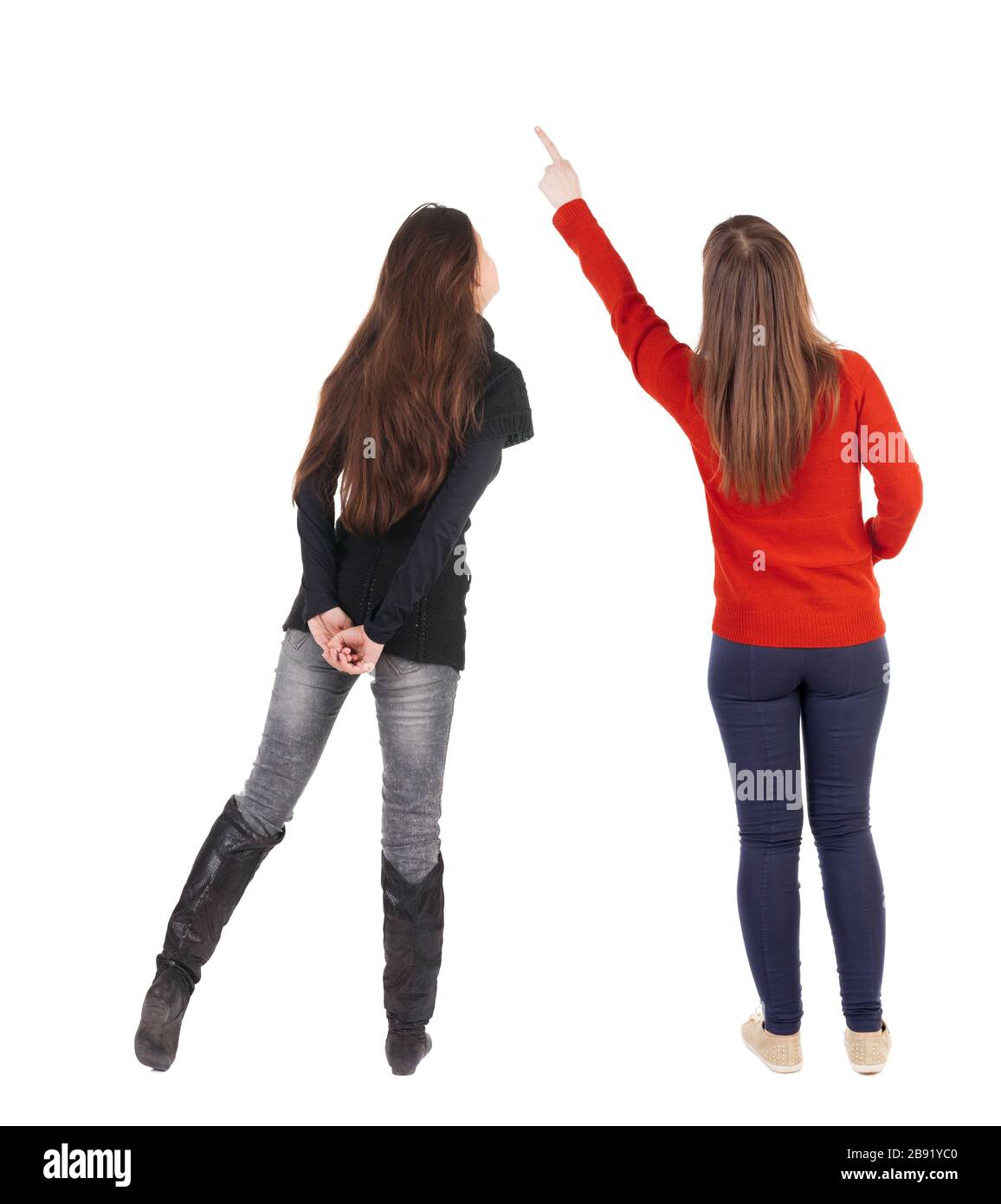 Back view of two pointing girl in sweater. Rear view people collection ...