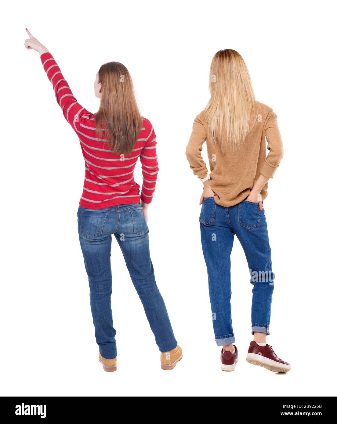 Back view of two pointing girl in sweater. Rear view people collection ...