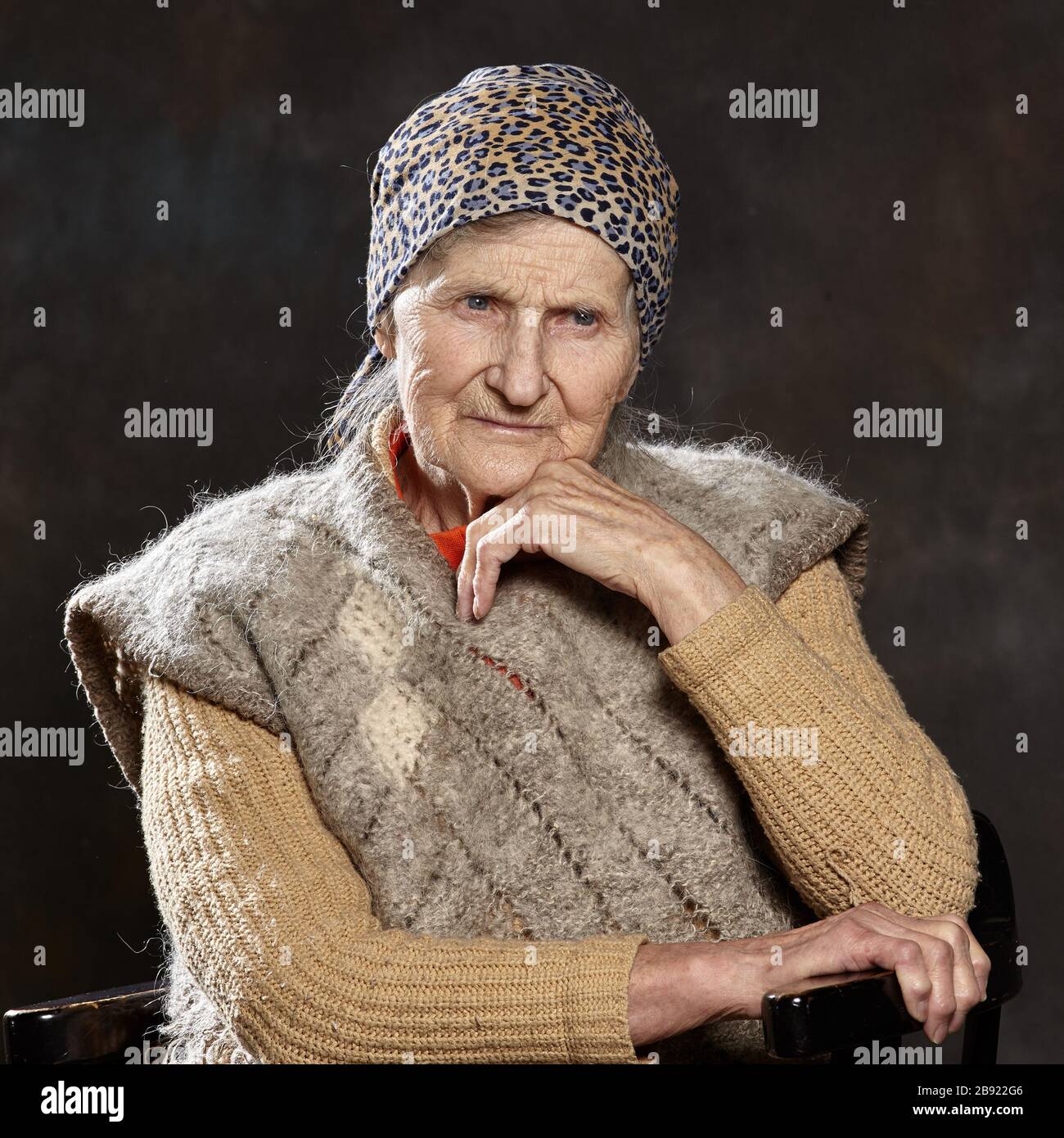 Portrait of old woman with brooding look on dark background. She rest ...