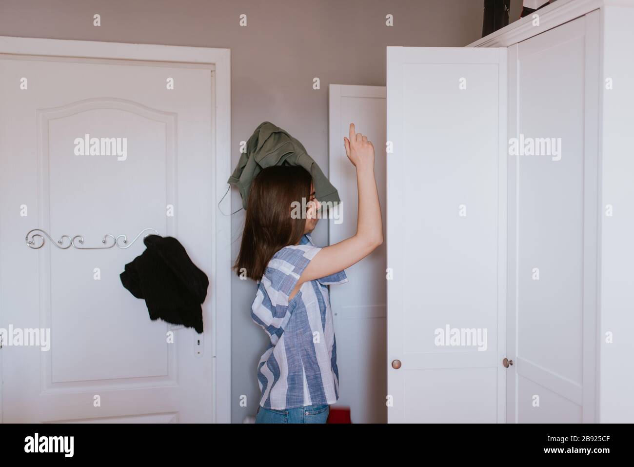 A teenage girl throws clothes out of her closet Stock Photo - Alamy