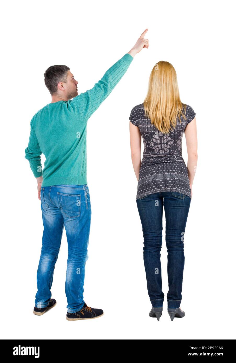 Back view of couple in sweater pointing. Rear view people collection ...
