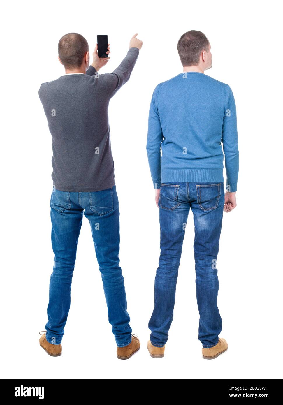 Back view of two man in sweater with mobile phone. Rear view people ...