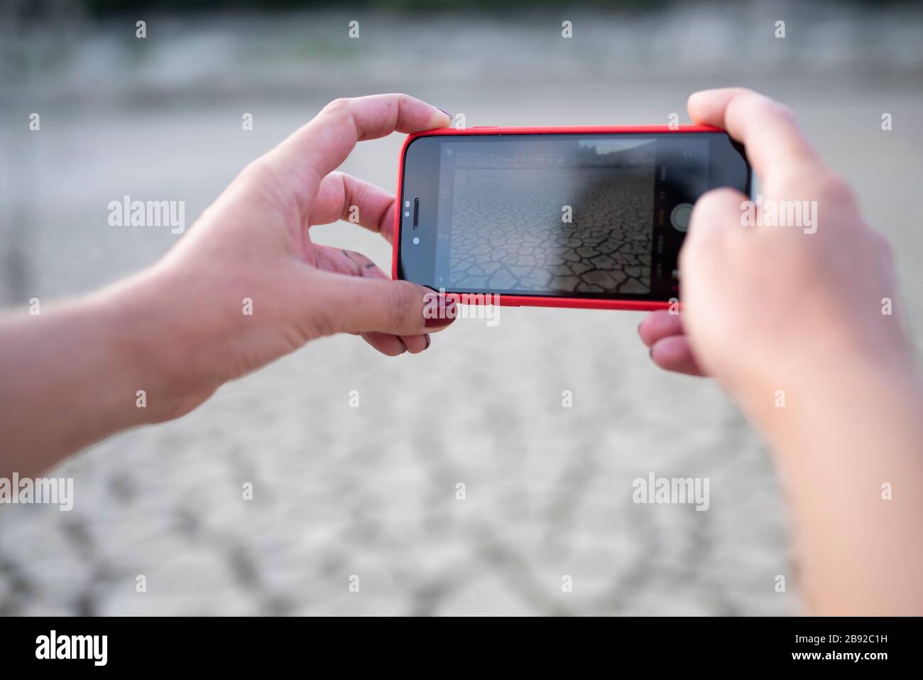 Close up of hands taking a photo with cellphone of landscape Stock ...