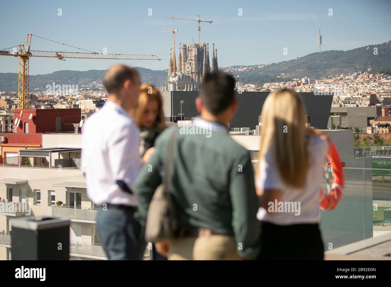 People on a rooftop watching La Sagrada Familia Stock Photo - Alamy