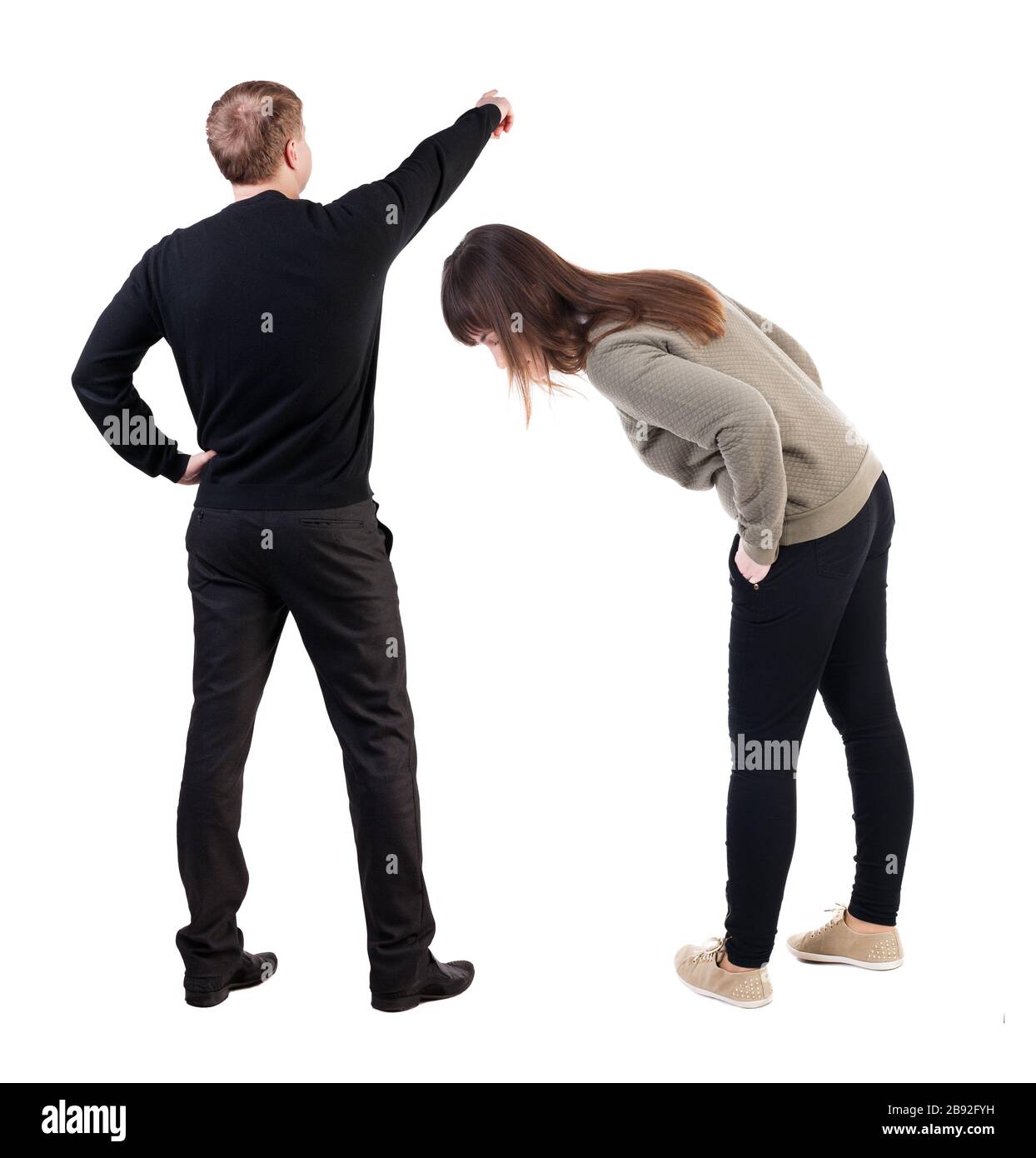Back view of couple in sweater pointing. Rear view people collection ...