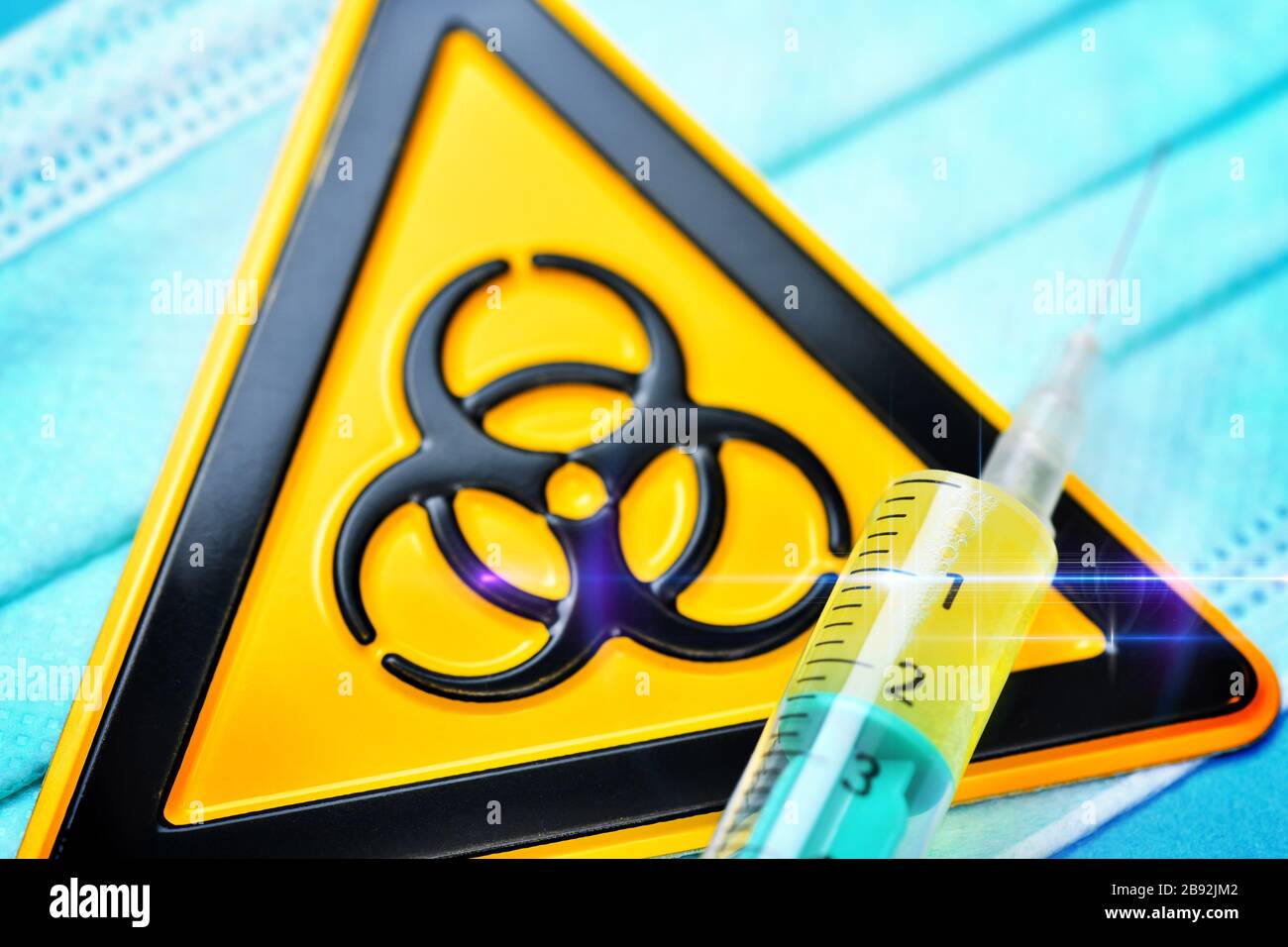 Syringe and biology danger sign on a mask, symbolic photo Coronavirus ...