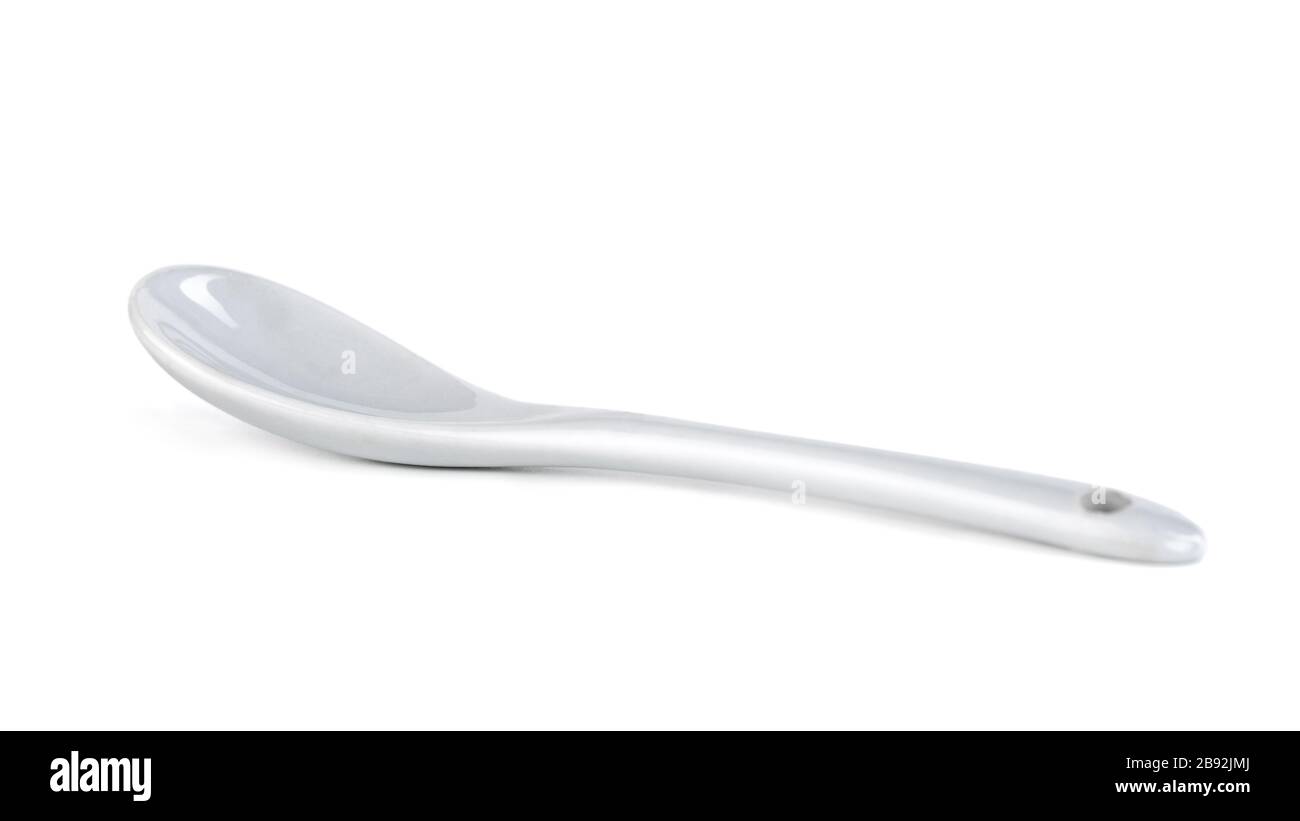 White ceramic spoon isolated on a white background Stock Photo - Alamy