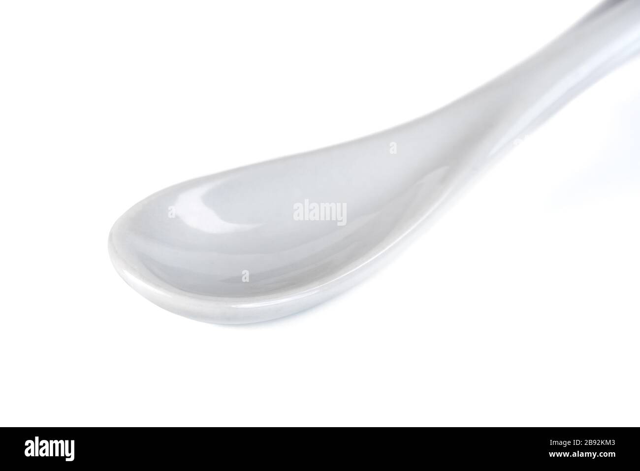 White ceramic spoon isolated on a white background Stock Photo - Alamy