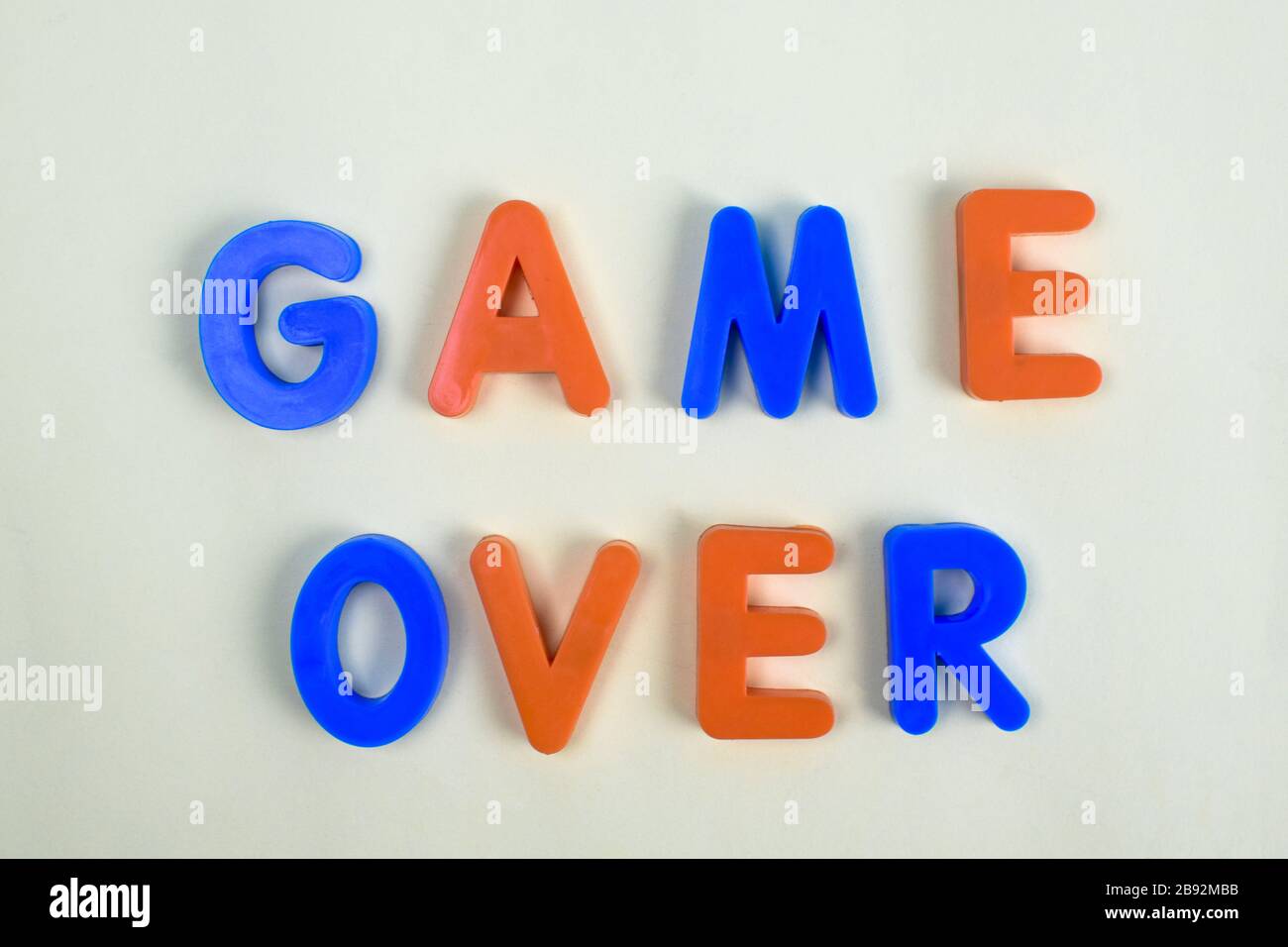 GAME OVER written in various colored letter blocks on an isolated white ...