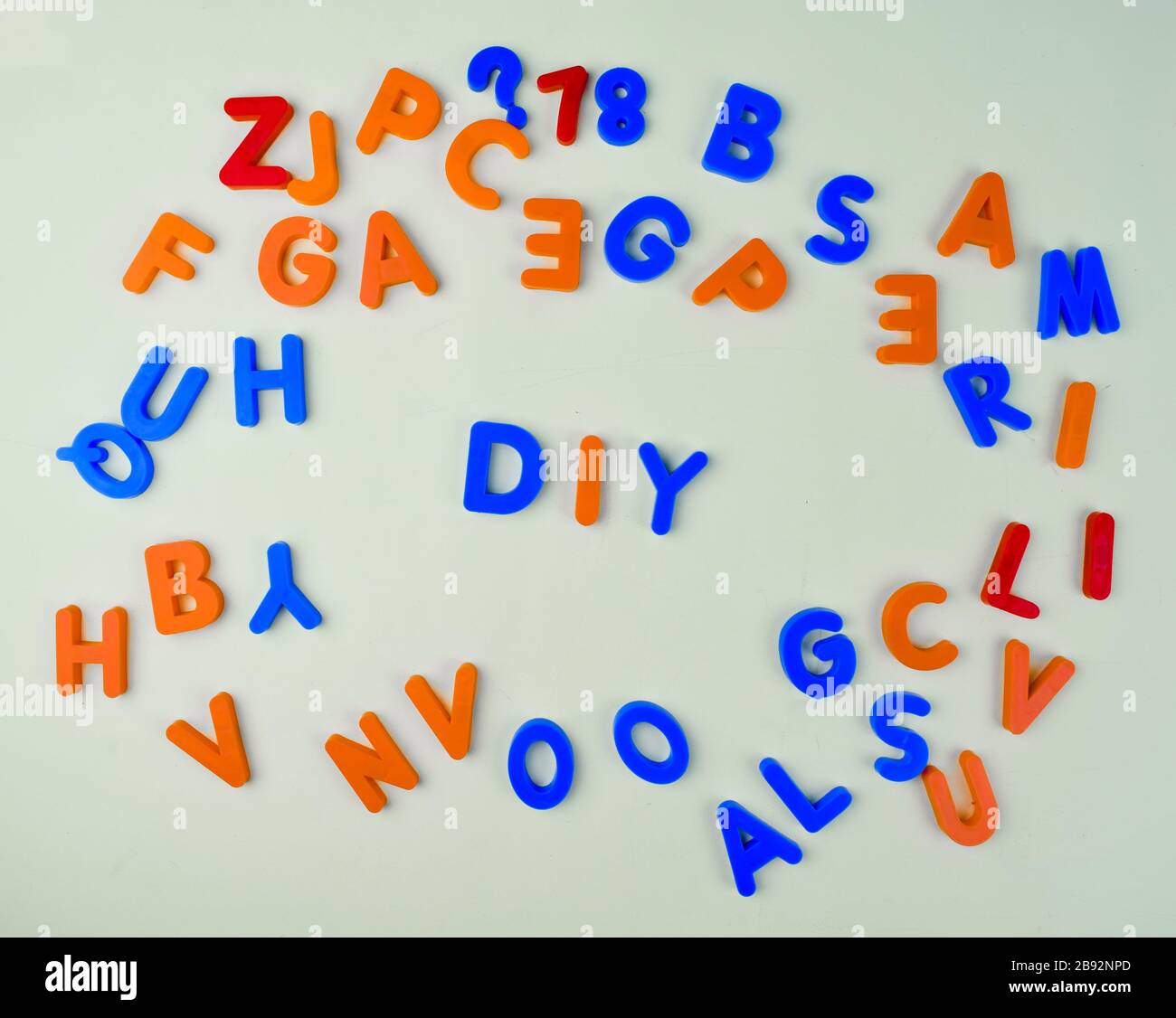 Various different colored letter blocks scattered across an isolated ...