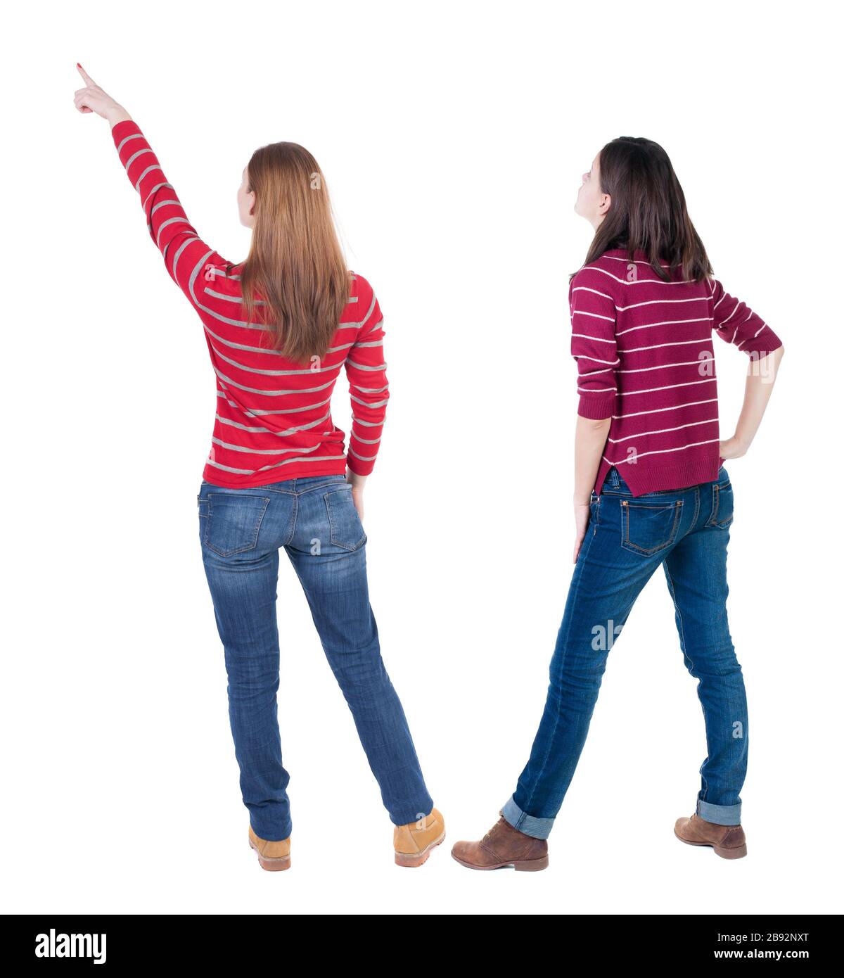 Back view of two pointing girl in sweater. Rear view people collection ...