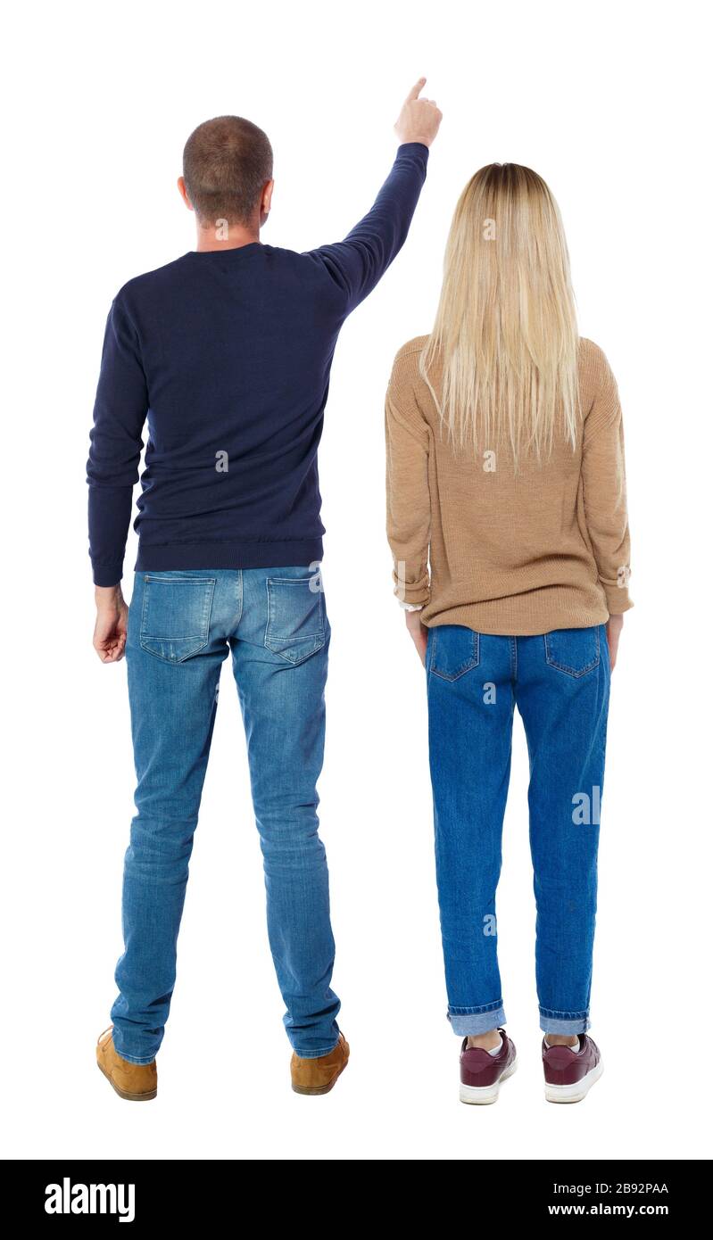Back view of couple in sweater pointing. Rear view people collection ...