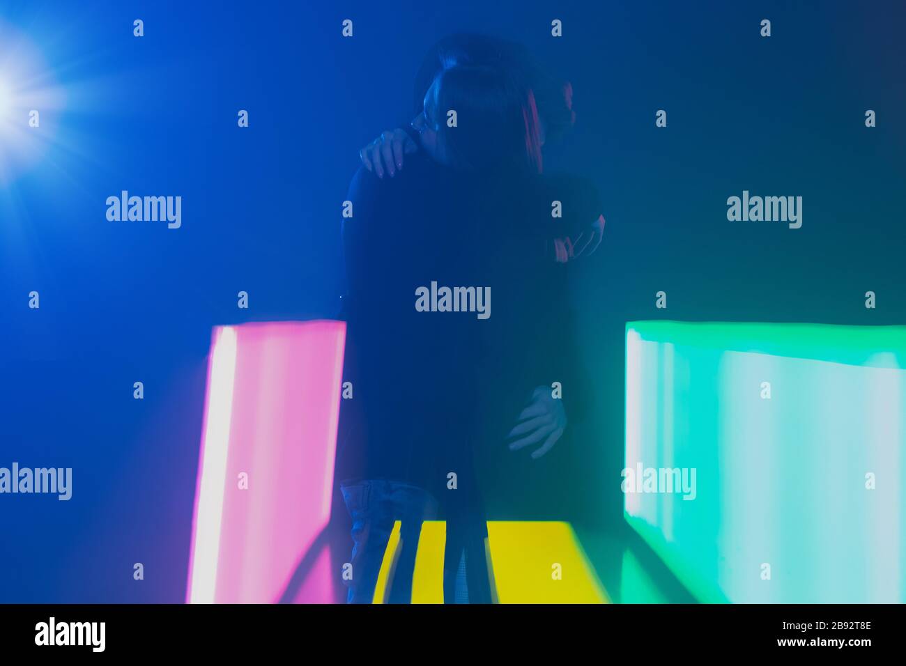 Caucasian young couple hugging in neon lights, looks romantic and ...