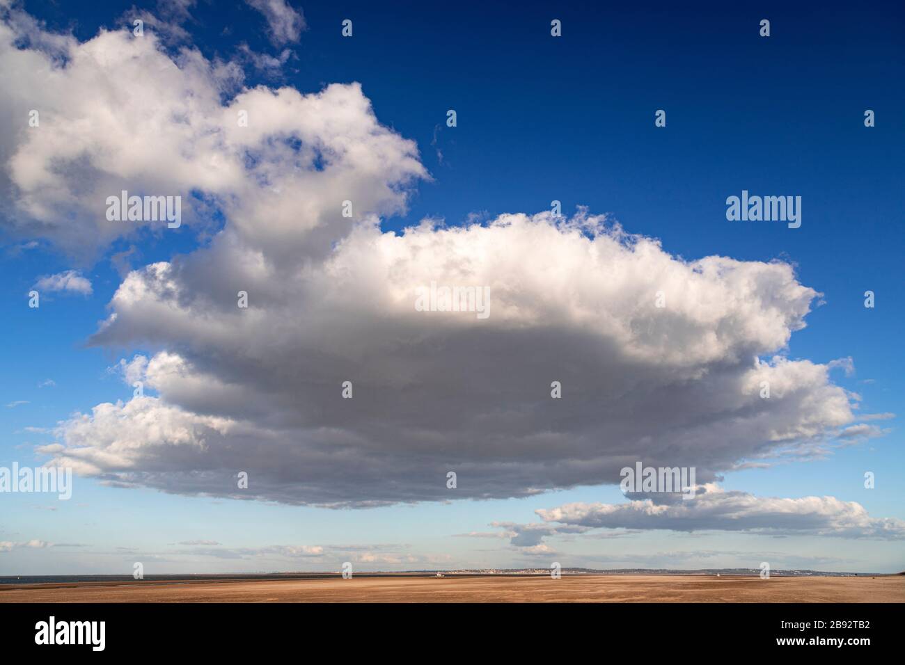 Cumulus cloud over the beach at Talacre on the North Wales coast Stock ...
