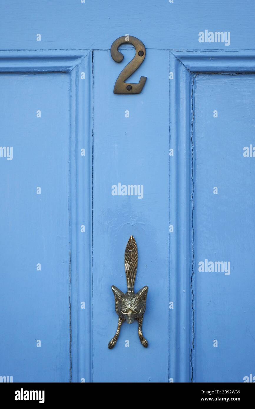 Close up of a golden / bronze house number sign with a fox on a blue ...