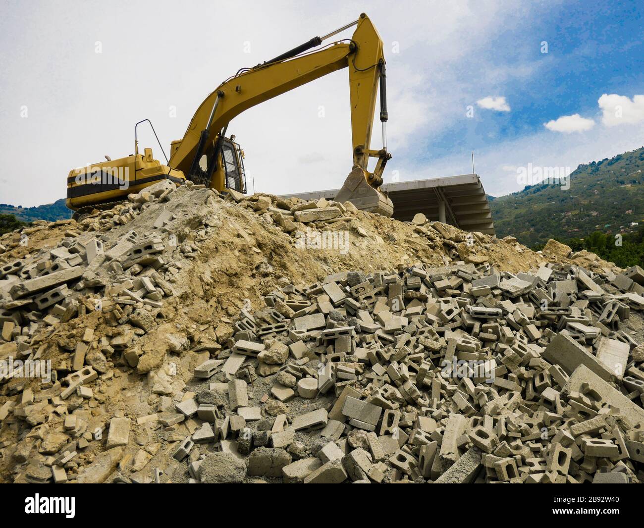 an excavator working on a construction and demolition waste plant Stock ...