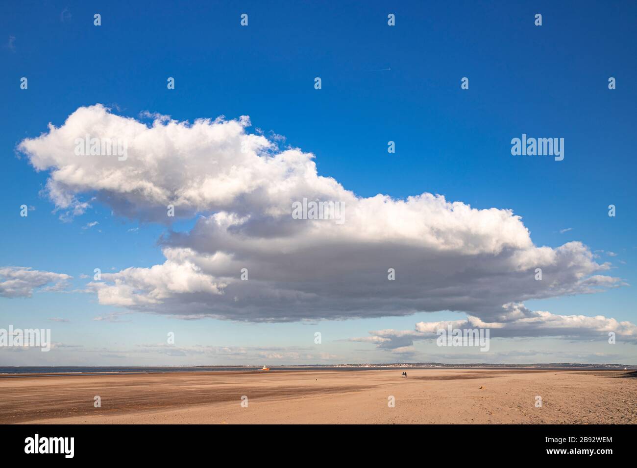 Cumulus cloud over the beach at Talacre on the North Wales coast Stock ...