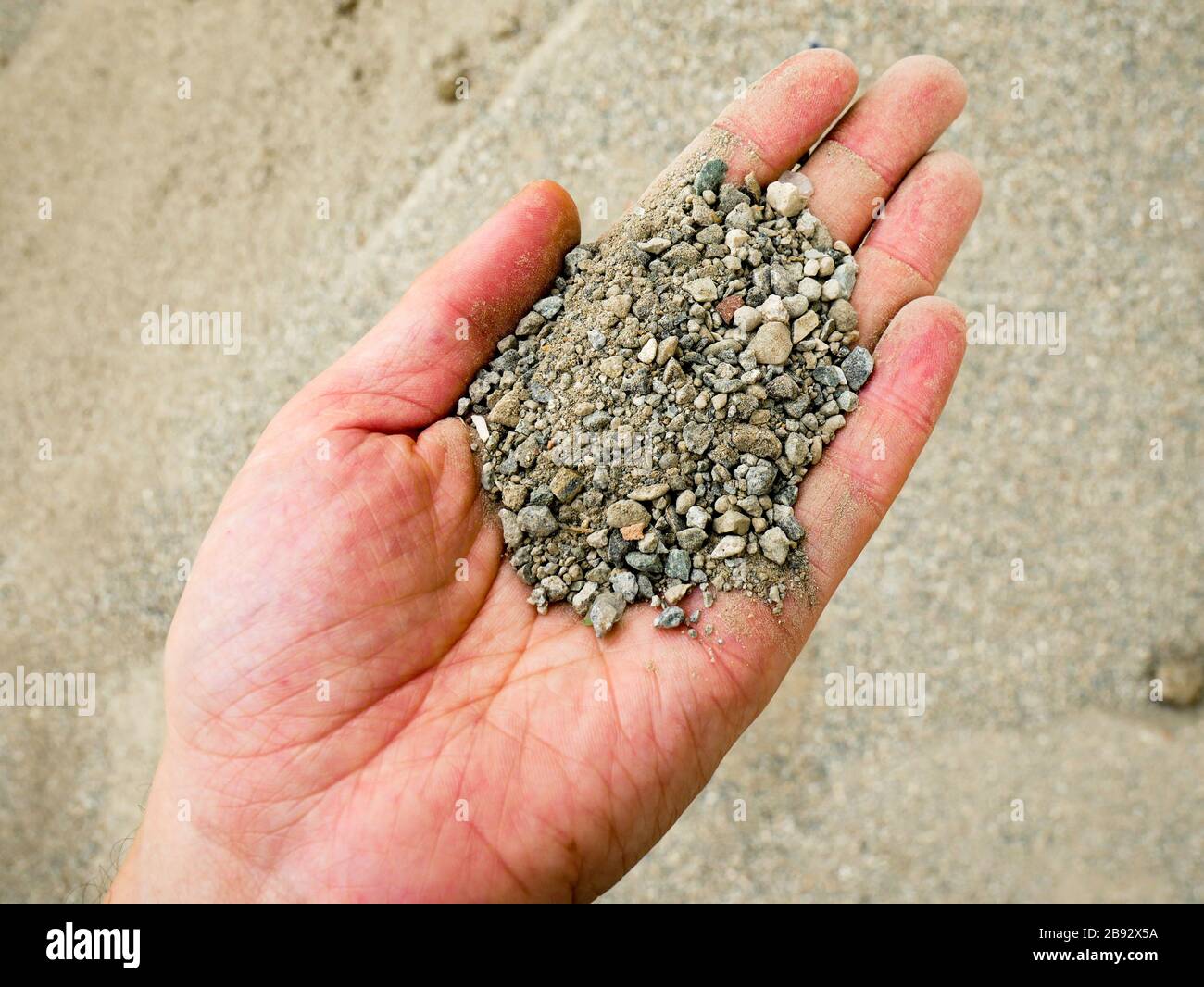 hand of a man with a grounded concrete in a construction and demolition ...