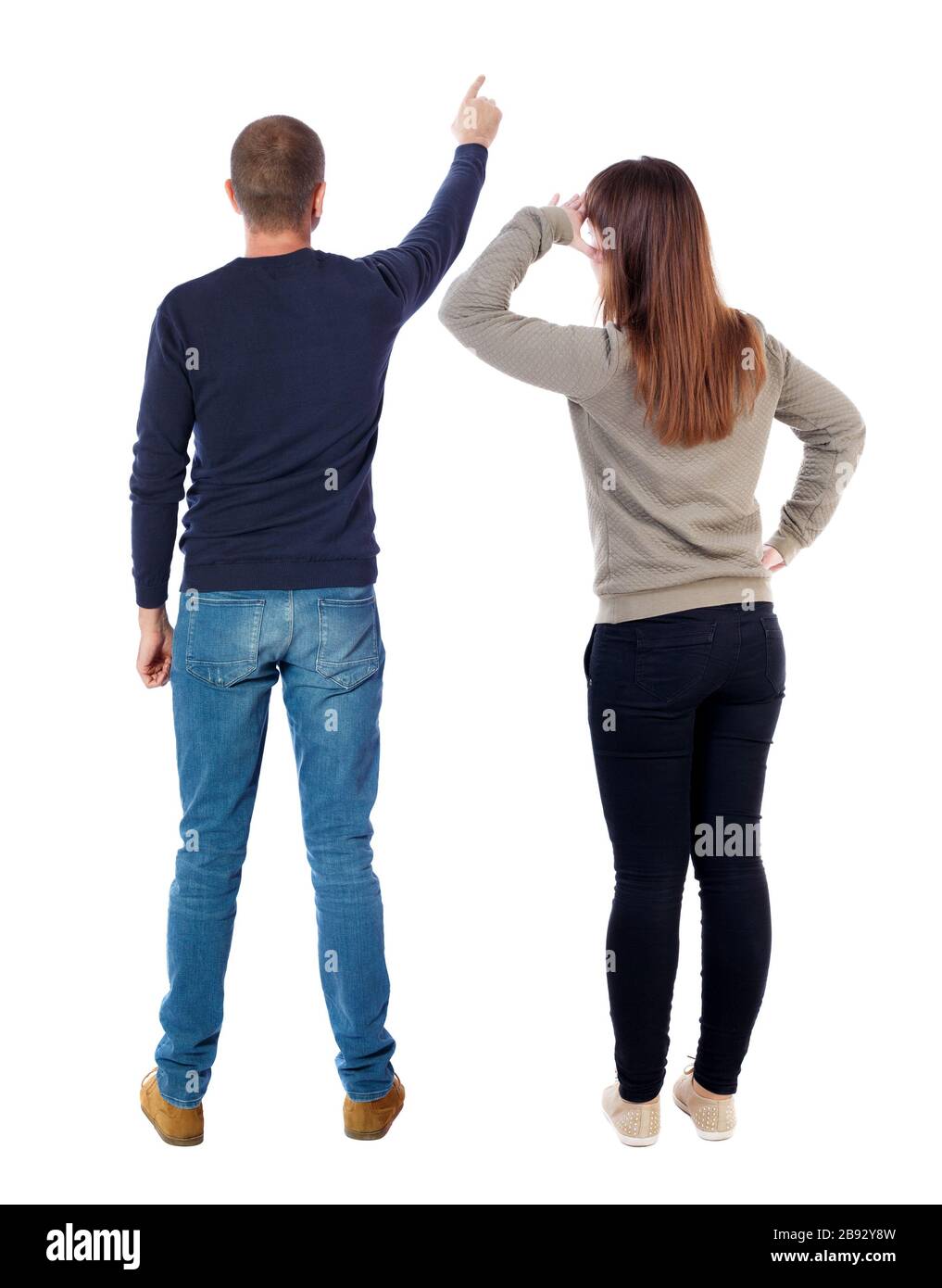 Back view of couple in sweater pointing. Rear view people collection ...