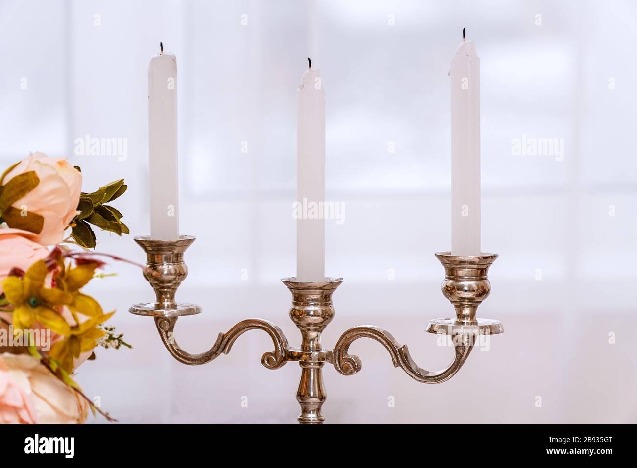 Antique gold candlestick with three candles on a light background Stock ...