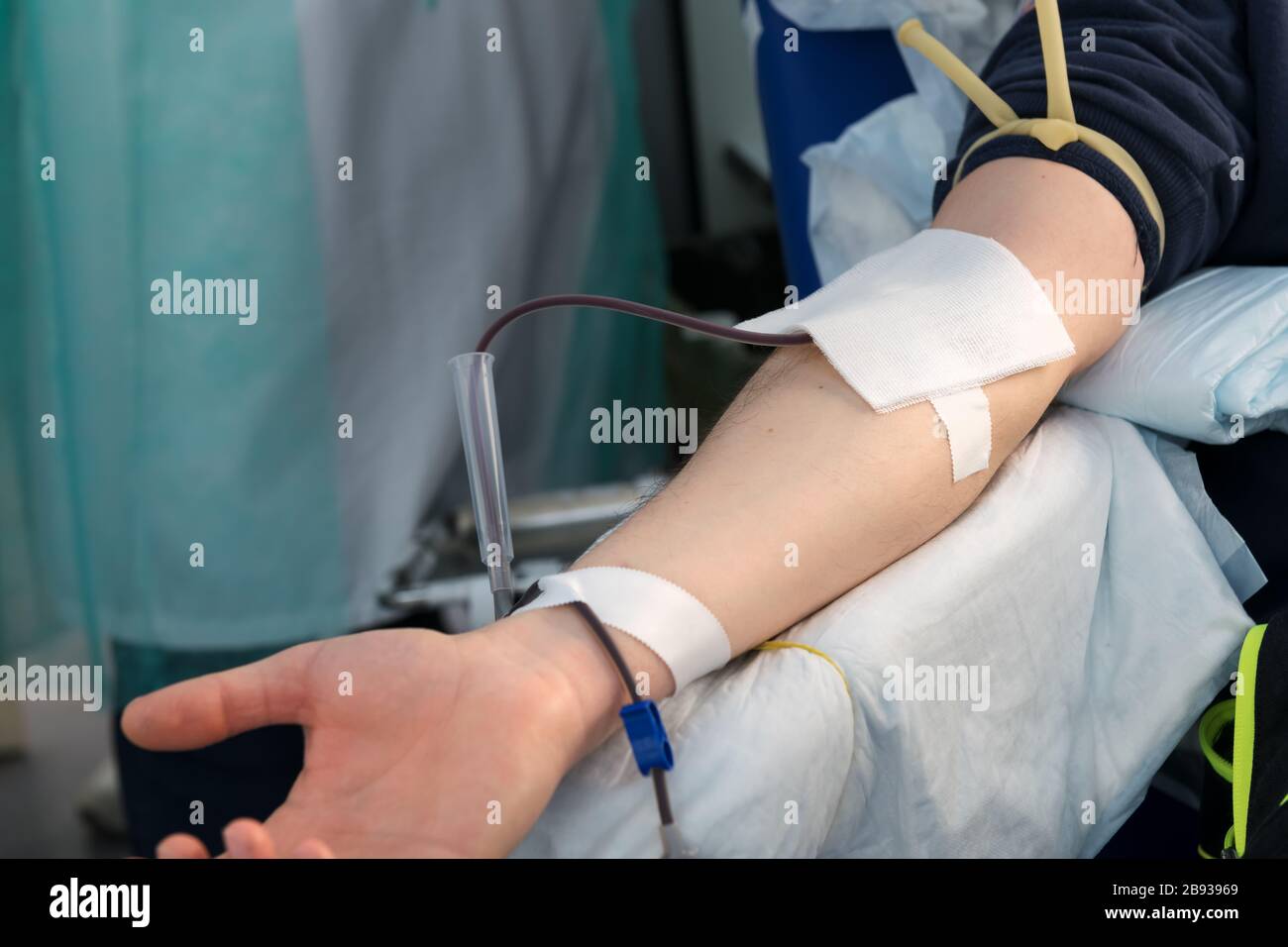 Close up arm of a man who donates blood. Male donor gives blood in a ...