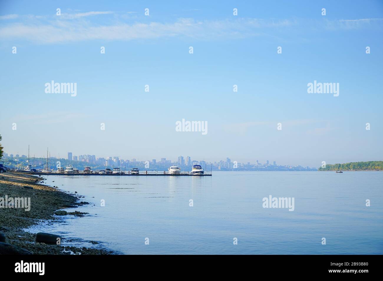 View of the big river, beyond which you can see the pier with boats and ...
