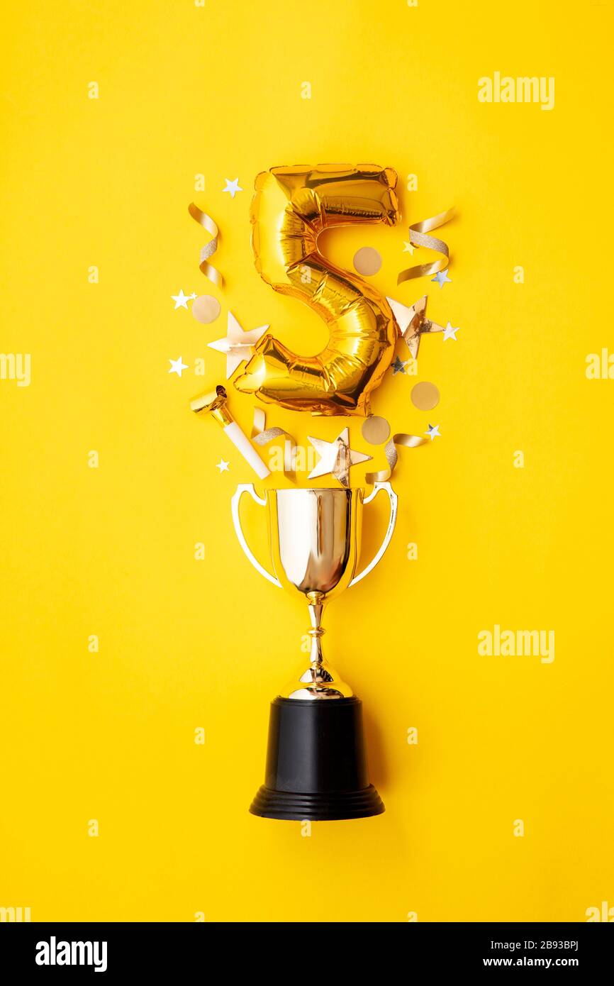 Number 5 gold anniversary celebration balloon exploding from a winning ...