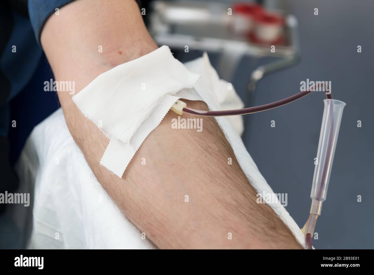 Close up arm of a man who donates blood. Male donor gives blood in a ...